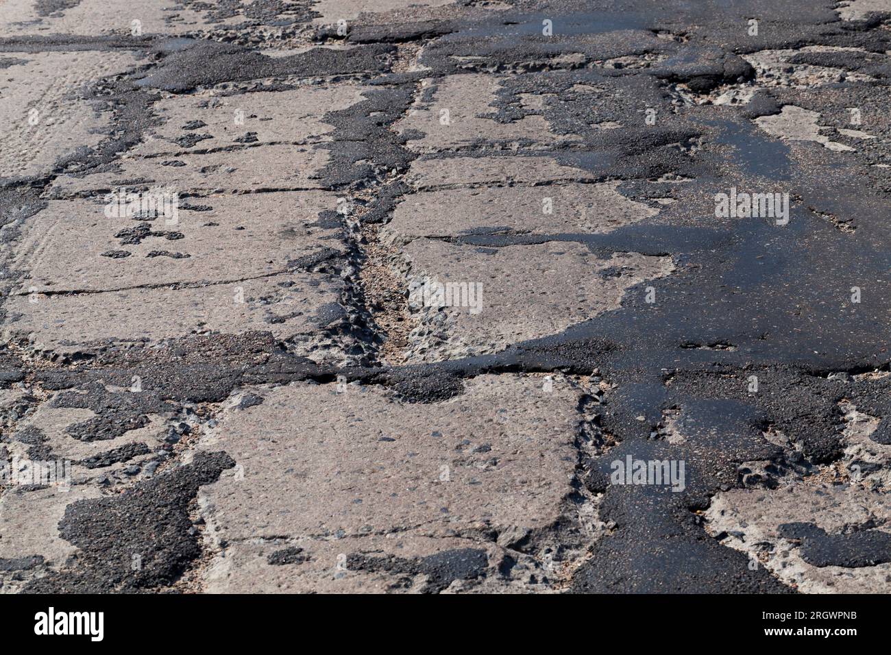 a road of poor quality has been repaired many times, a bad road with ...