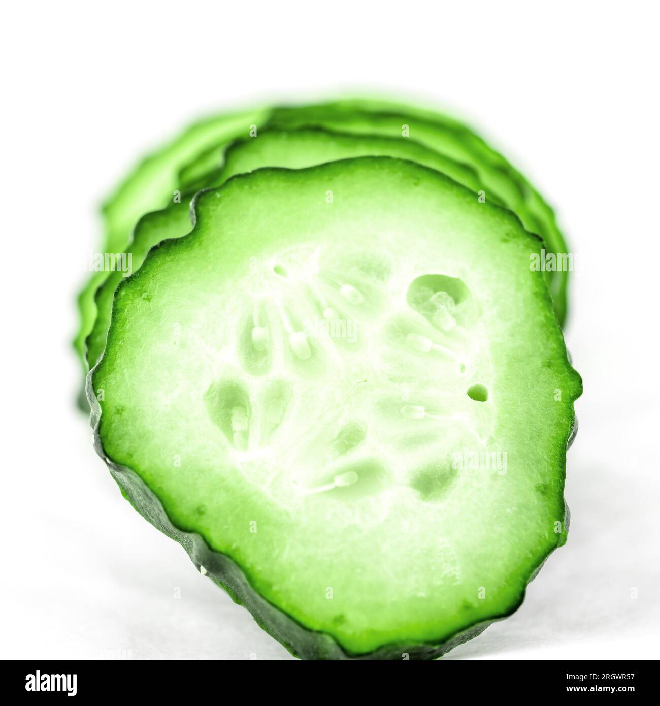 Cucumber slices on a white background. Light shadow Stock Photo - Alamy