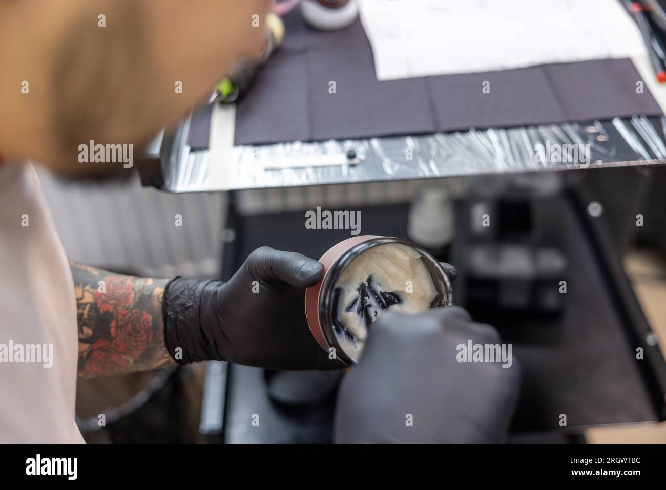 Tattoo master preparing equipment for tattoo session Stock Photo - Alamy