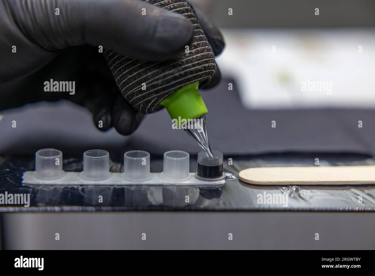 Tattoo master preparing equipment for tattoo session Stock Photo - Alamy