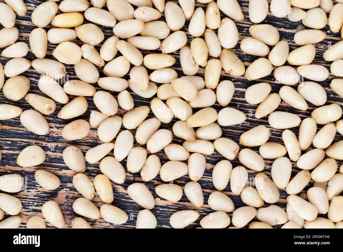 peeled pine nuts of small size, useful nuts, a part of the shell ...