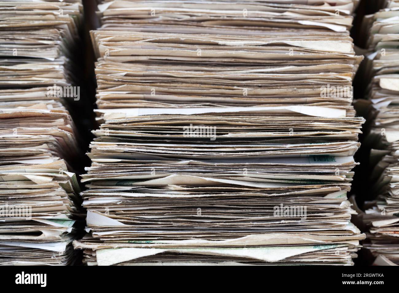 a large amount of old crumpled and dirty money, stacked in huge piles ...