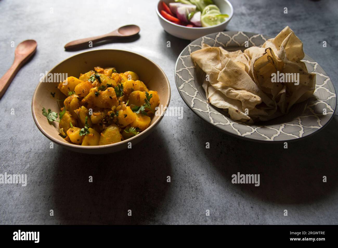 Popular Indian veg lunch rumali roti or Indian bread and alu jeera or ...