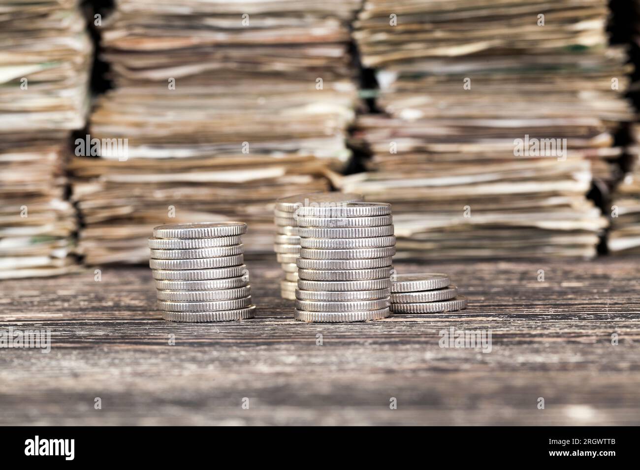 a large amount of old crumpled and dirty money, stacked in huge piles ...