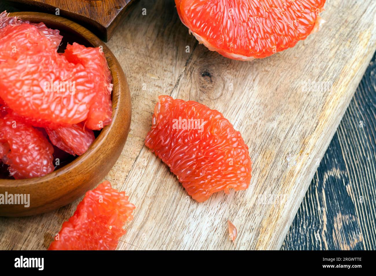 peeled pink grapefruit split into pieces while cooking, ready to eat ...