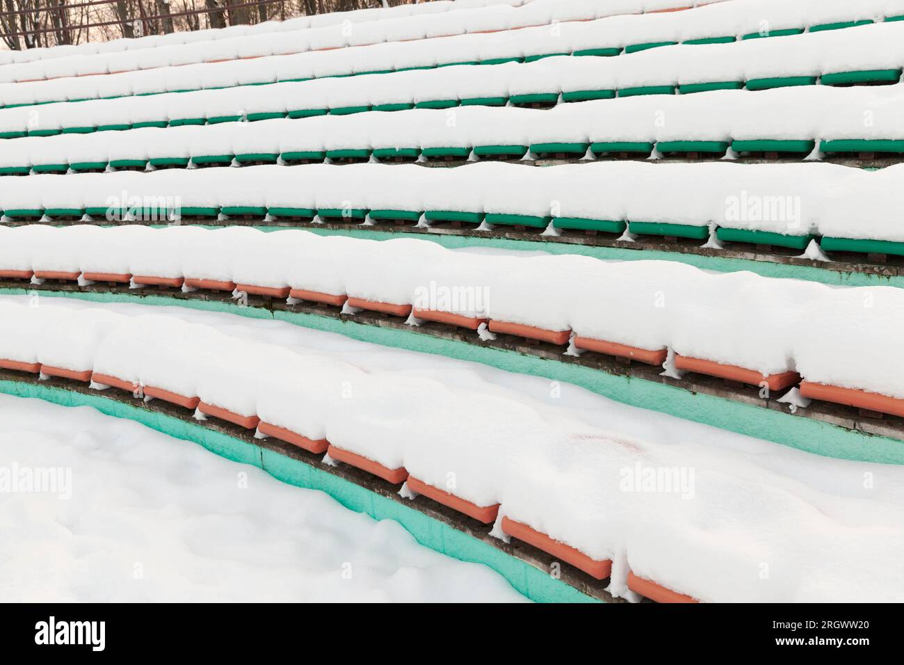 stadium and stadium seats in snow in winter, stadium seats covered with ...