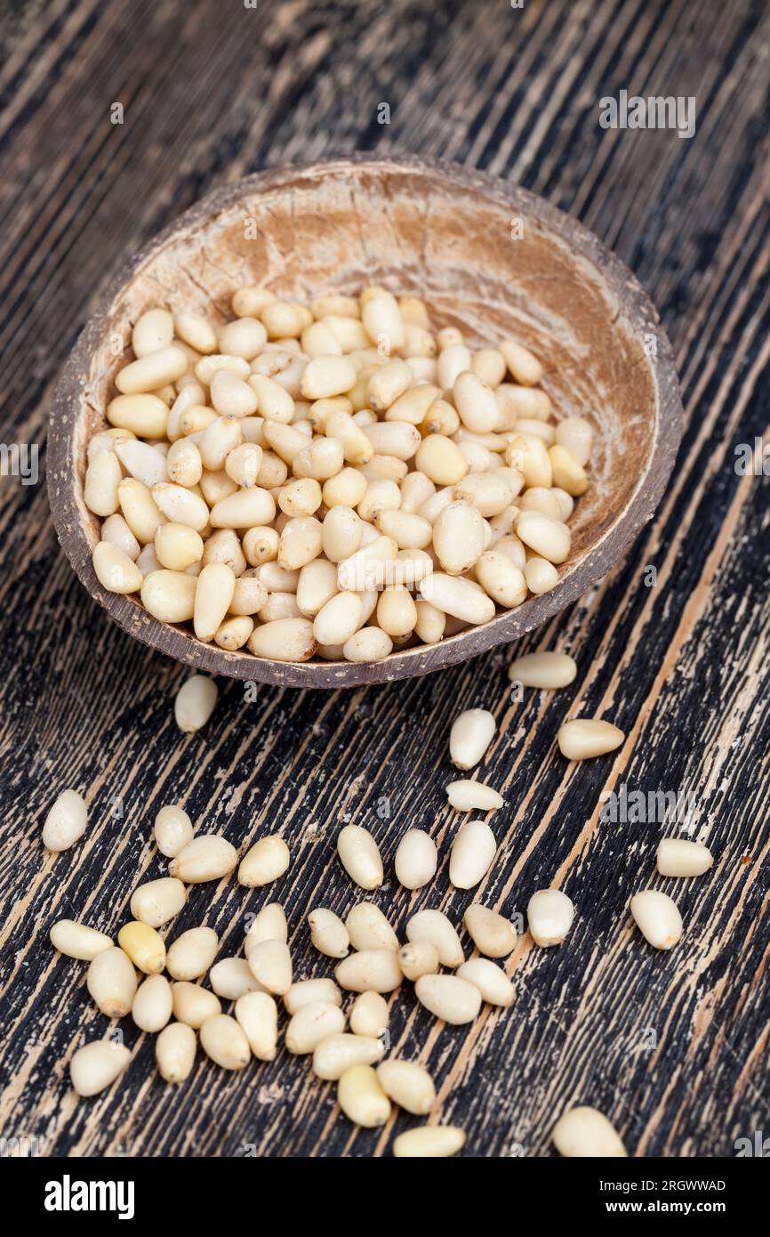 peeled pine nuts of small size, useful nuts, a part of the shell ...
