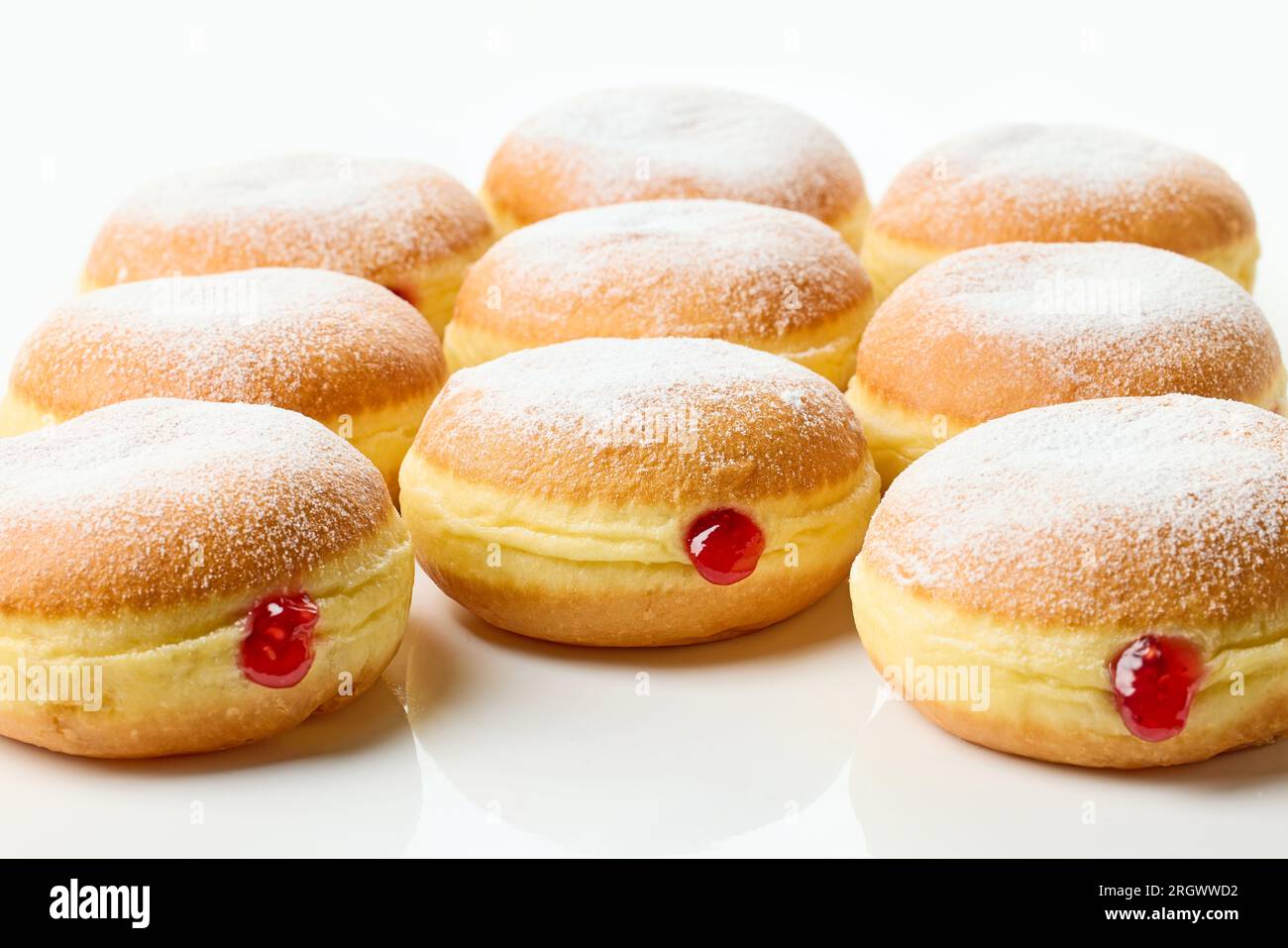 freshly baked jelly donuts on white background Stock Photo - Alamy