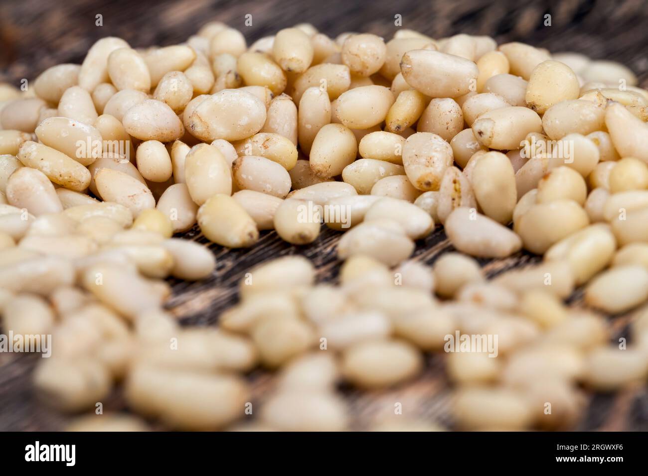 peeled pine nuts of small size, useful nuts, a part of the shell ...