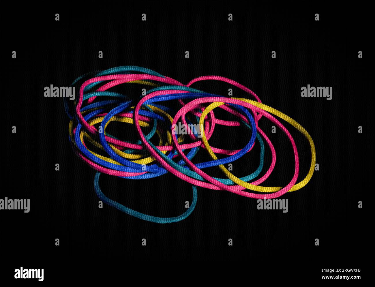 A closeup image of colorful rubber bands photographed with a black ...