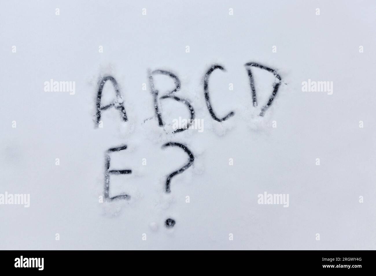 painted letters and a question mark on the snow in the winter season in ...