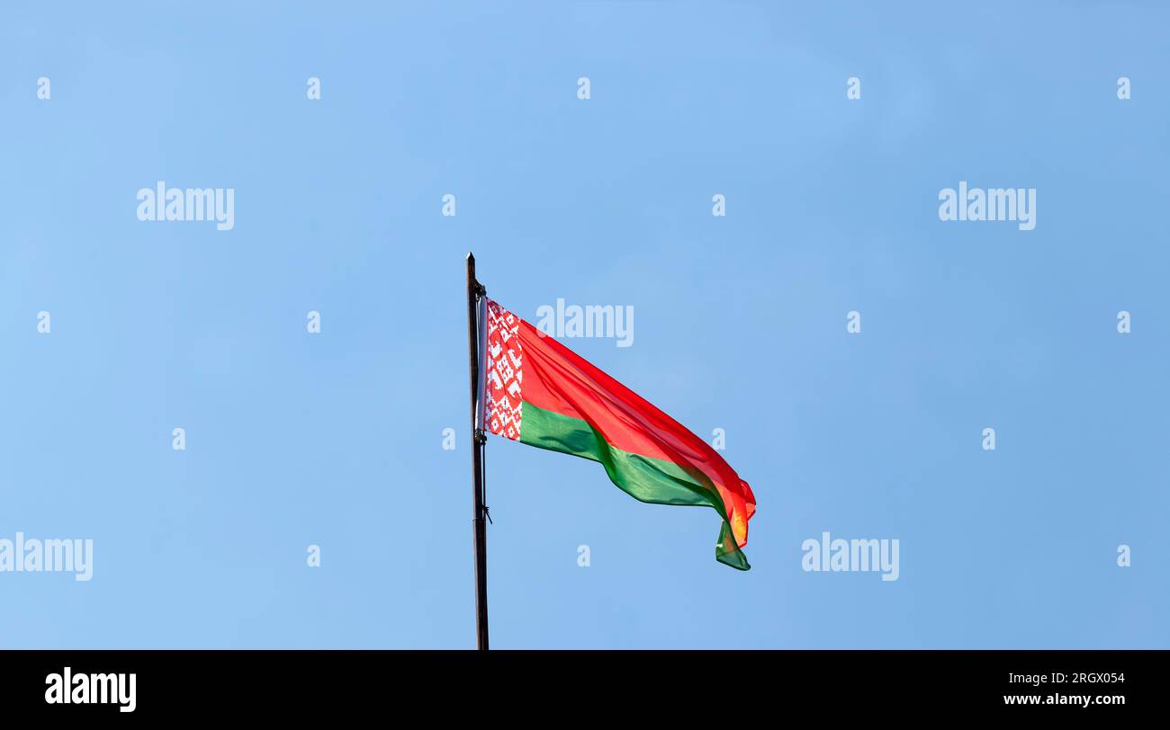 belarusian state flag on a blue sky background, the official state flag ...