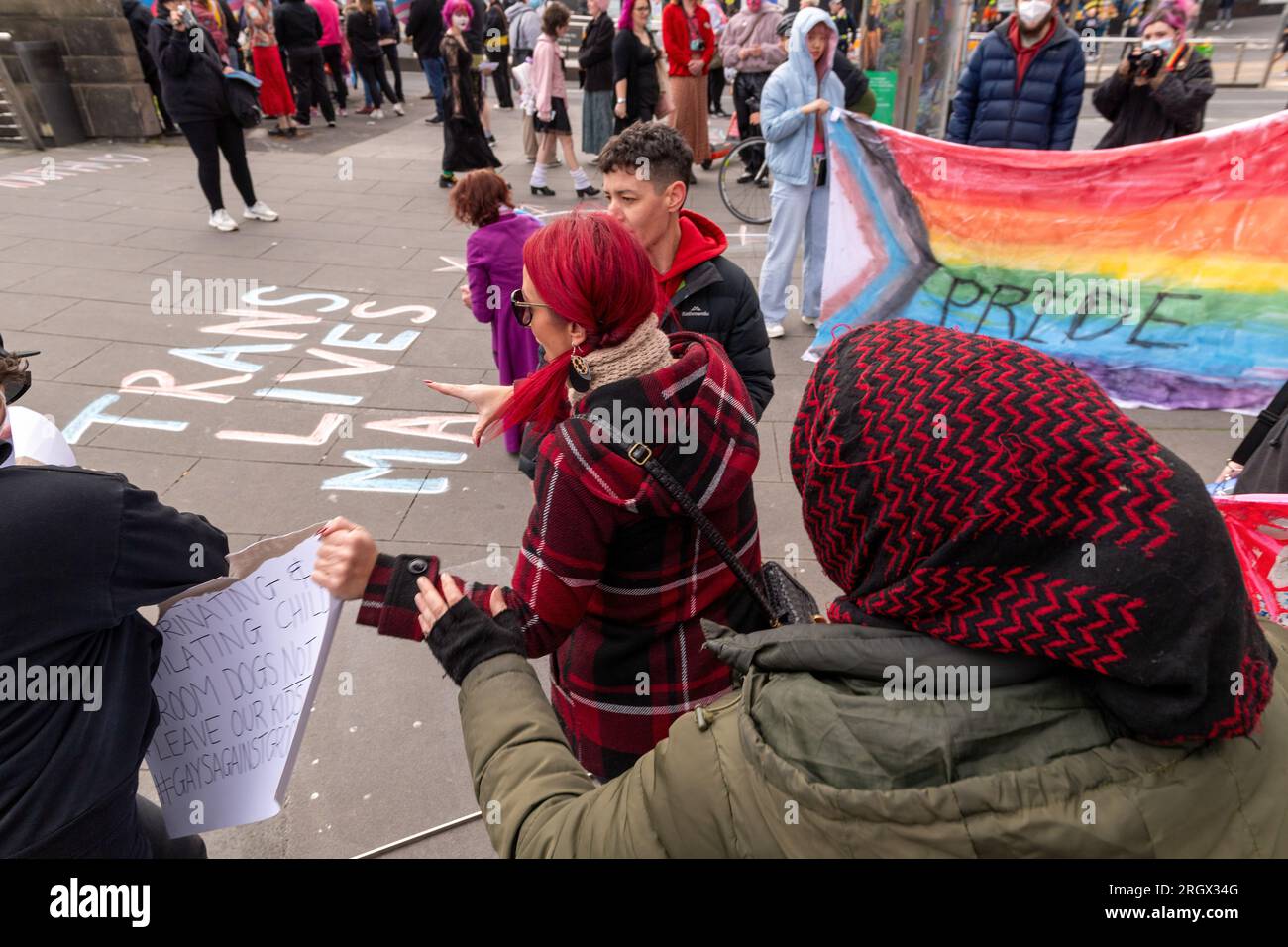 A pro LGBT protester rips an anti-trans protest sign from the hands of ...