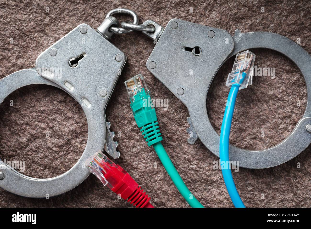 Network wires and handcuffs on an abstract background, a concept on the ...