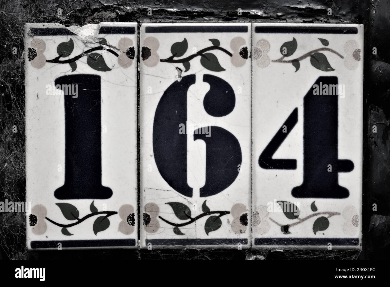 Number 164. An old house number plate. Black and white image Stock ...