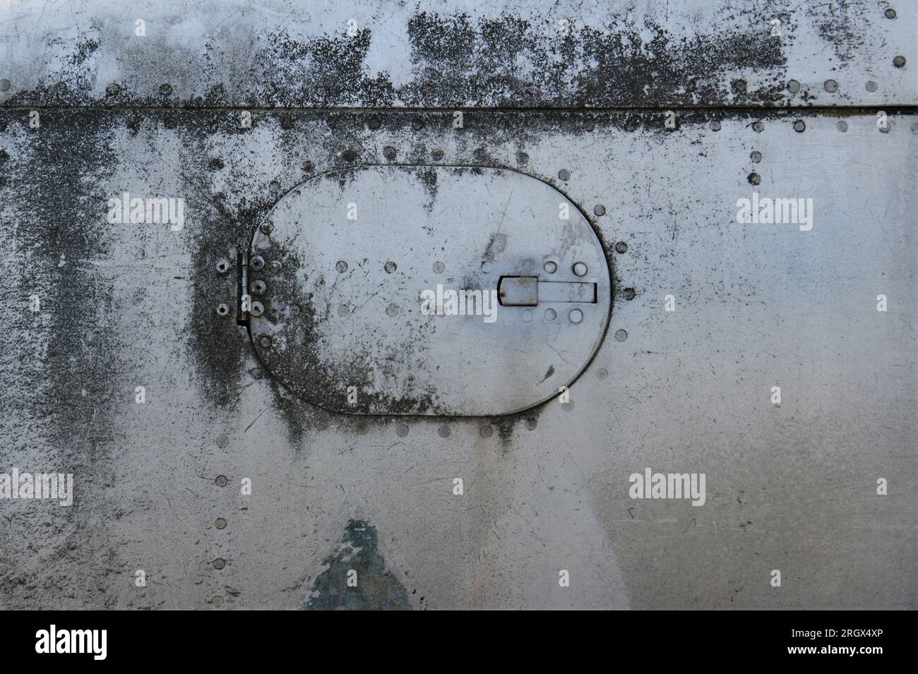 A fragment of an old airplane fuselage with rivets and a hatch Stock ...