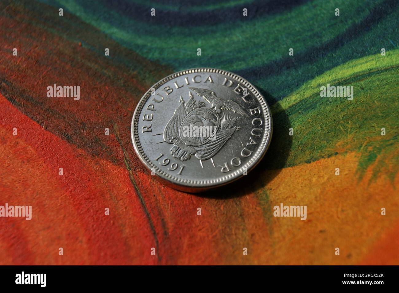Demonetized Ecuadorian coin on a colorful background. 5 Sucres 1991 ...