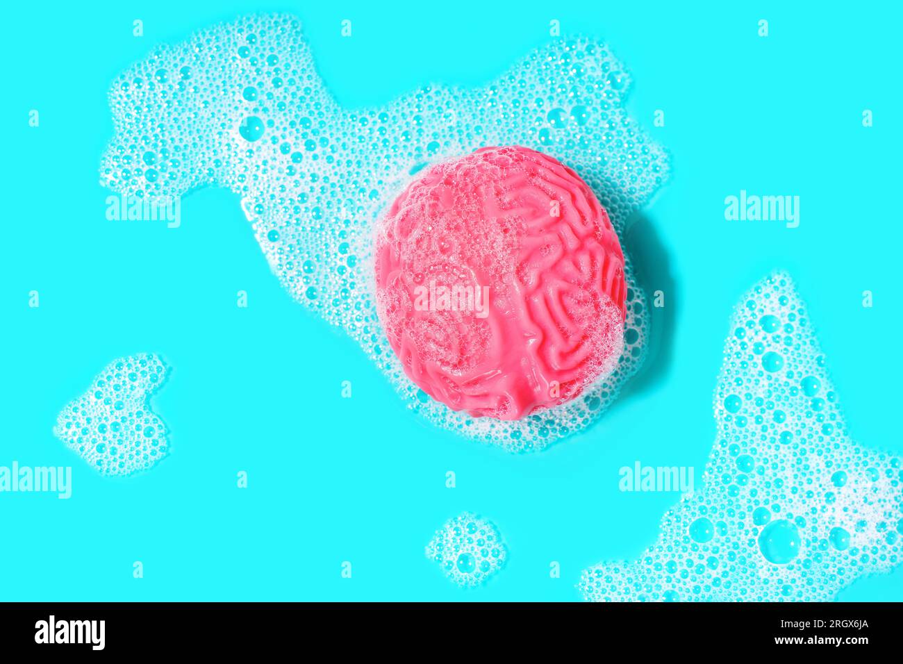 Jelly-like human brain model rests in a shallow pool of water, adorned ...