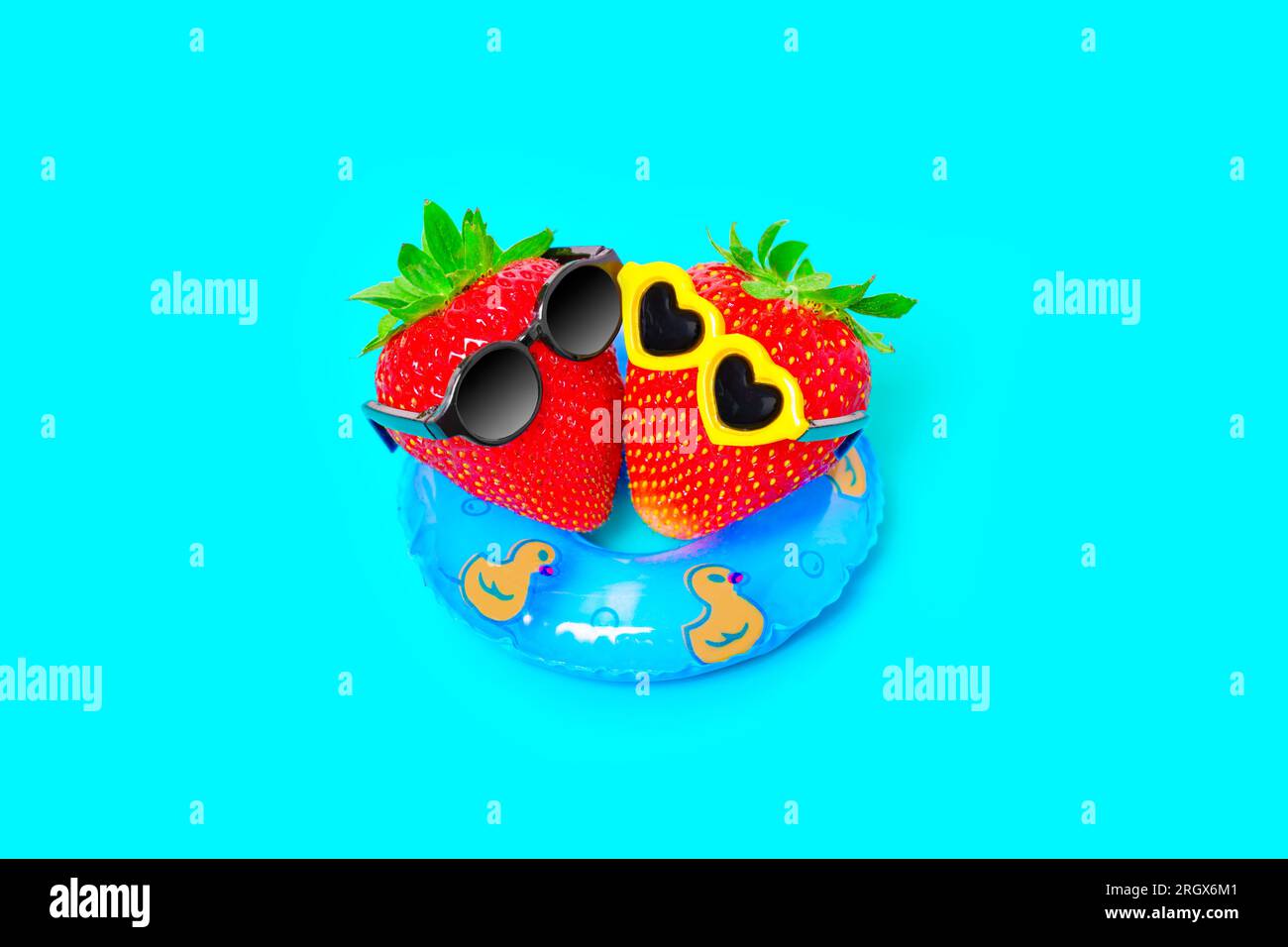 Refreshing joy of summer: Top-down view of a strawberry duo, donning ...