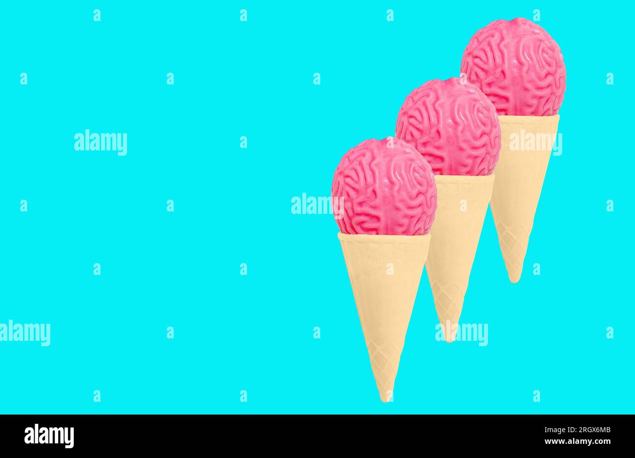 Three human brain models in waffle ice cream cones isolated on blue ...