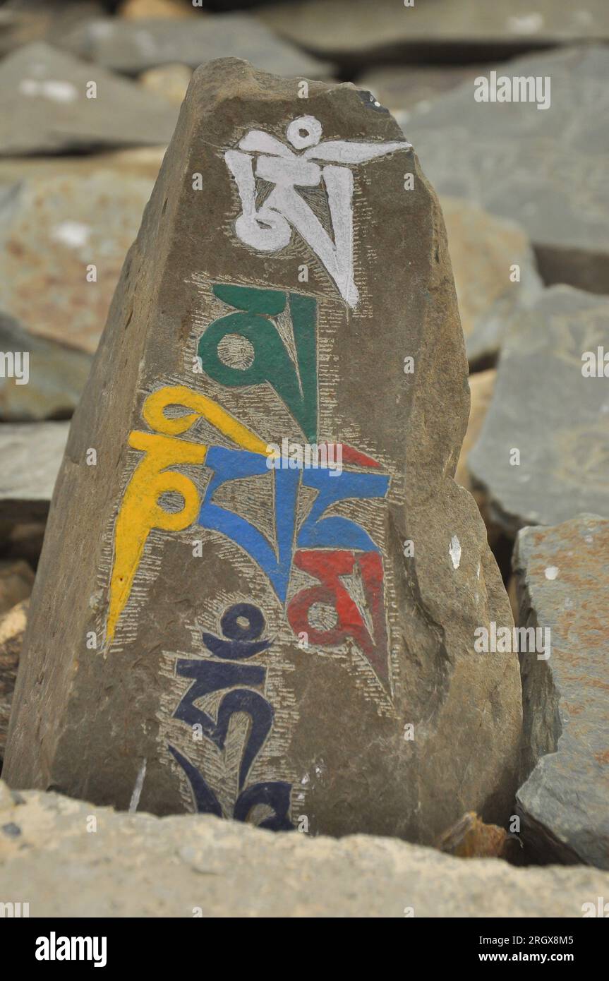 Closeup of engraved stone with Buddhist mantra Om Mani Padme Hum in ...