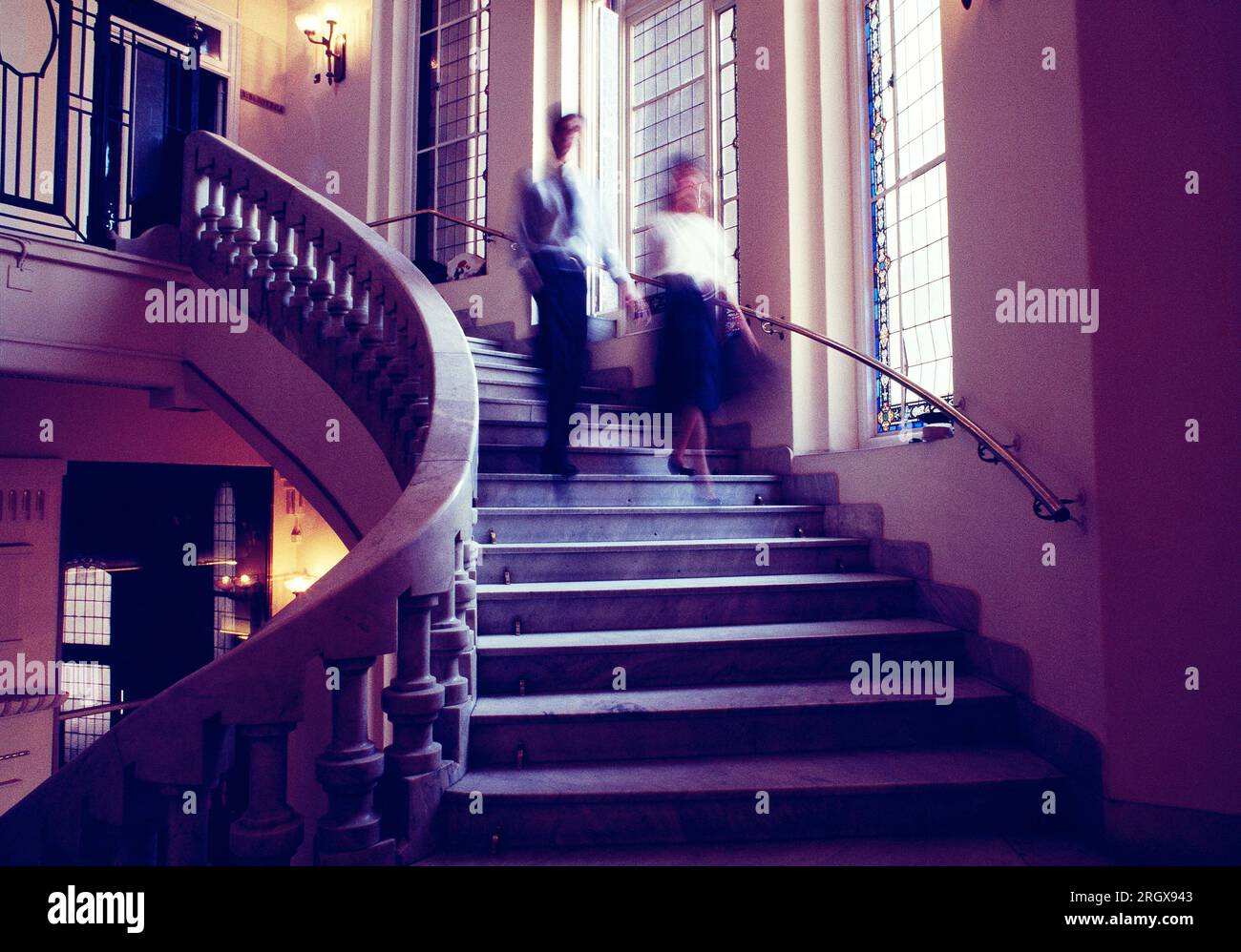 Young couple going down stairs Stock Photo - Alamy