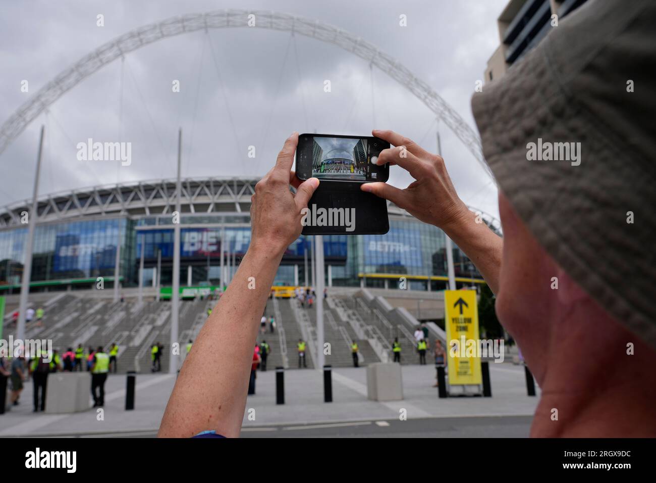 A fan take a photo of Wembley Stadium the Betfred Challenge Cup match ...