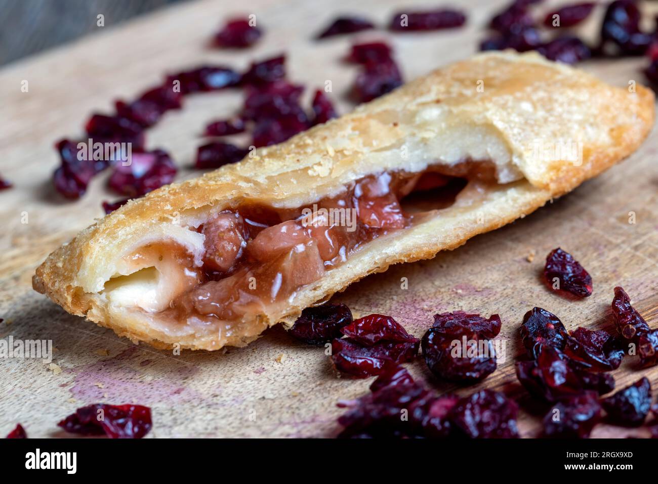 wheat pastries with red cherry strawberry filling on a board, dried ...