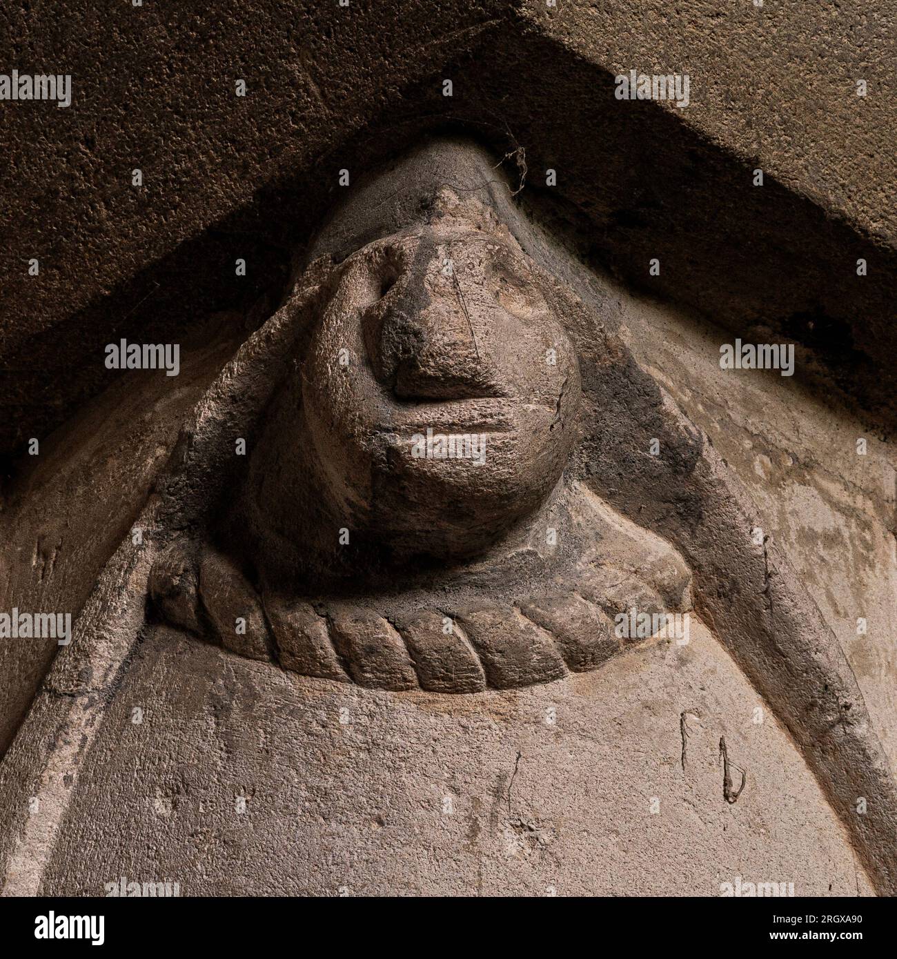 Head carved in stone in early Norman period. On capital of pillar ...