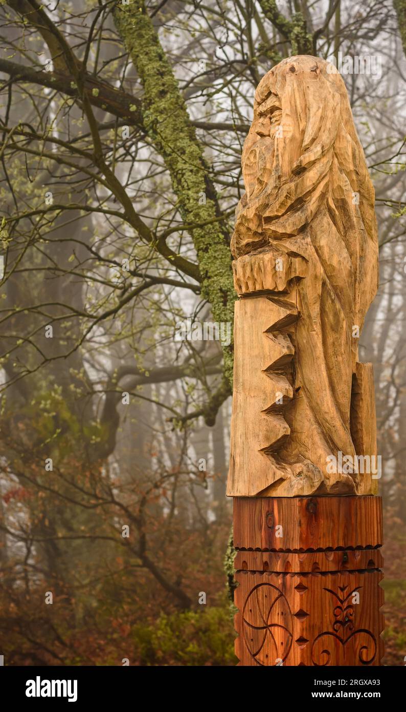 A wooden totem in the shape of an idol of the ancient pagan religion ...