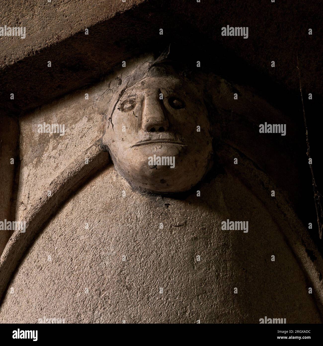 Face carved on capital of pillar supporting early Norman chancel arch ...