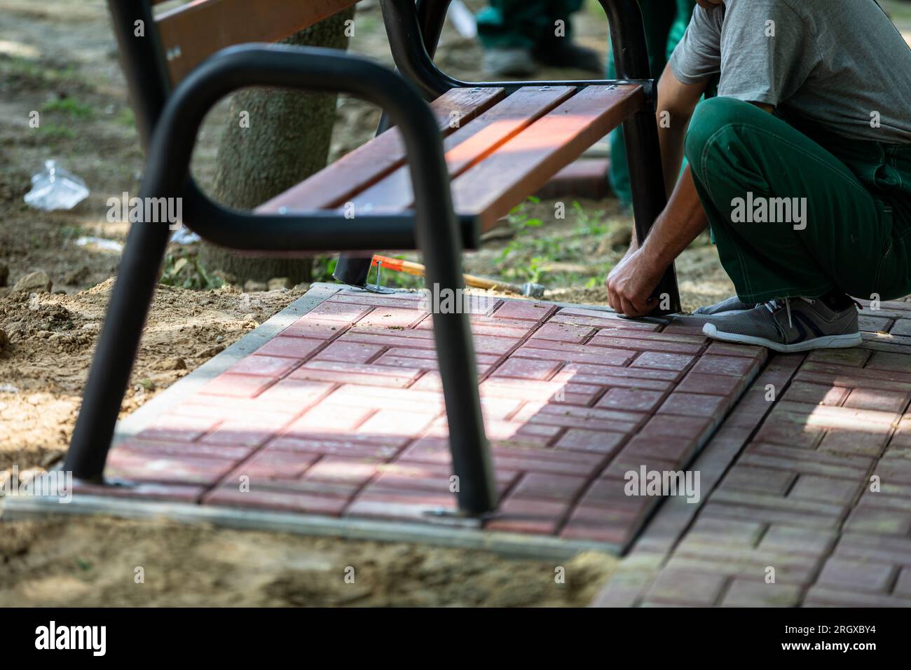 Installation of a park bench for paving stones in a designated place in ...
