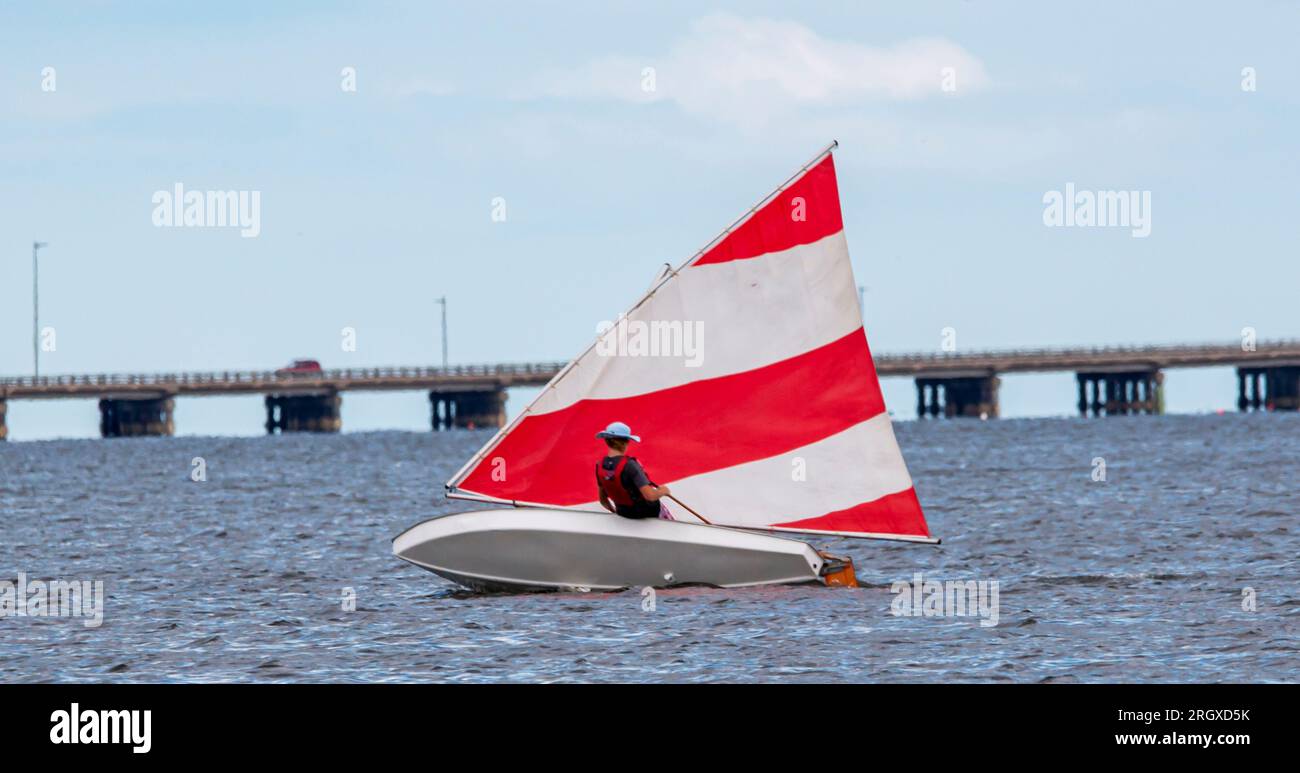 Rear view of a sailer out sailing in a sunfish in the Great South Bay ...