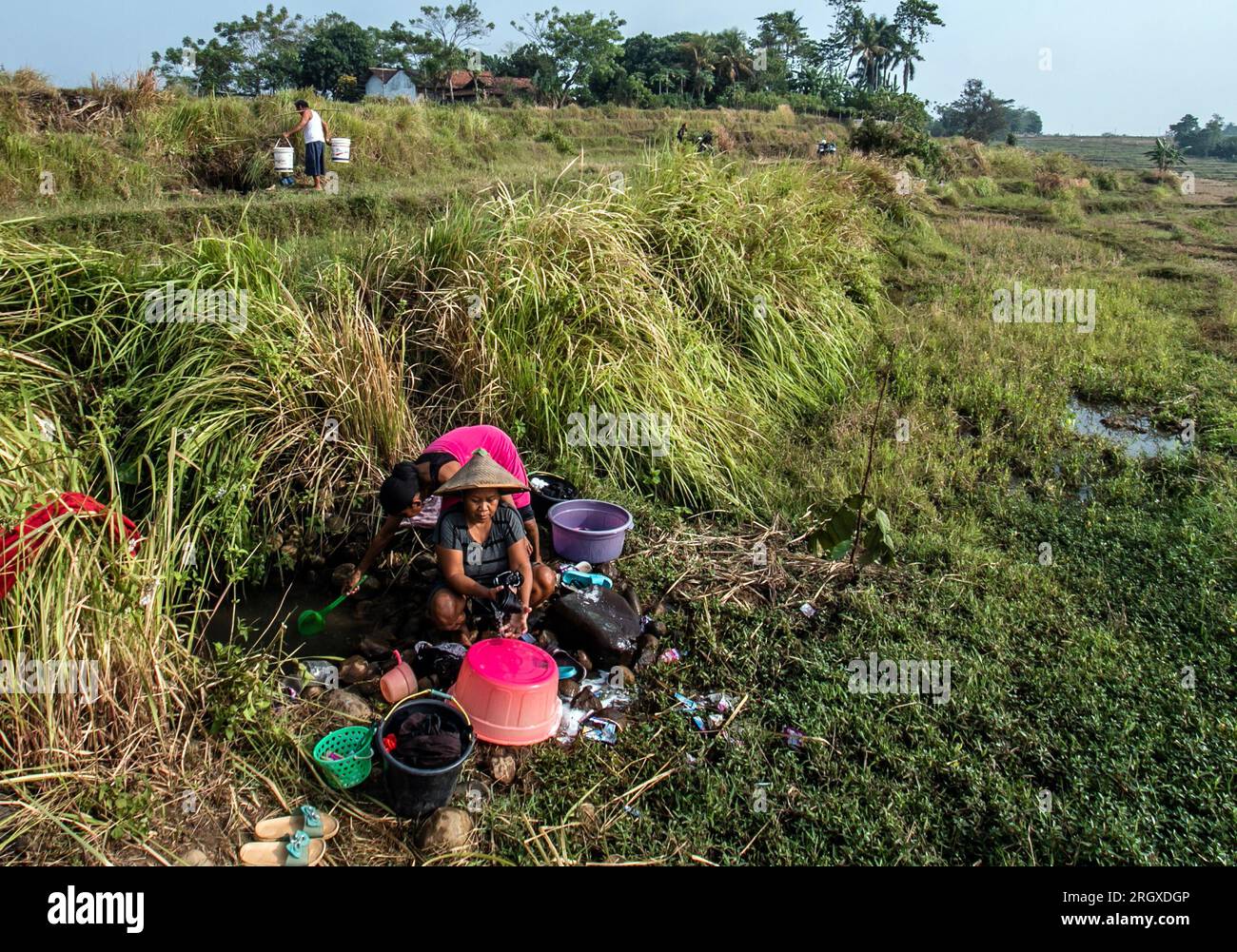 Bogor, Indonesia. 12th Aug, 2023. Residents wash their clothes using ...