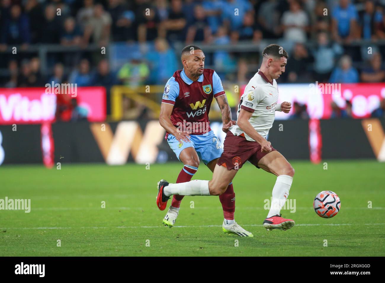 Burnley FC's Vitinho (left) and Manchester City's Phil Foden (right ...