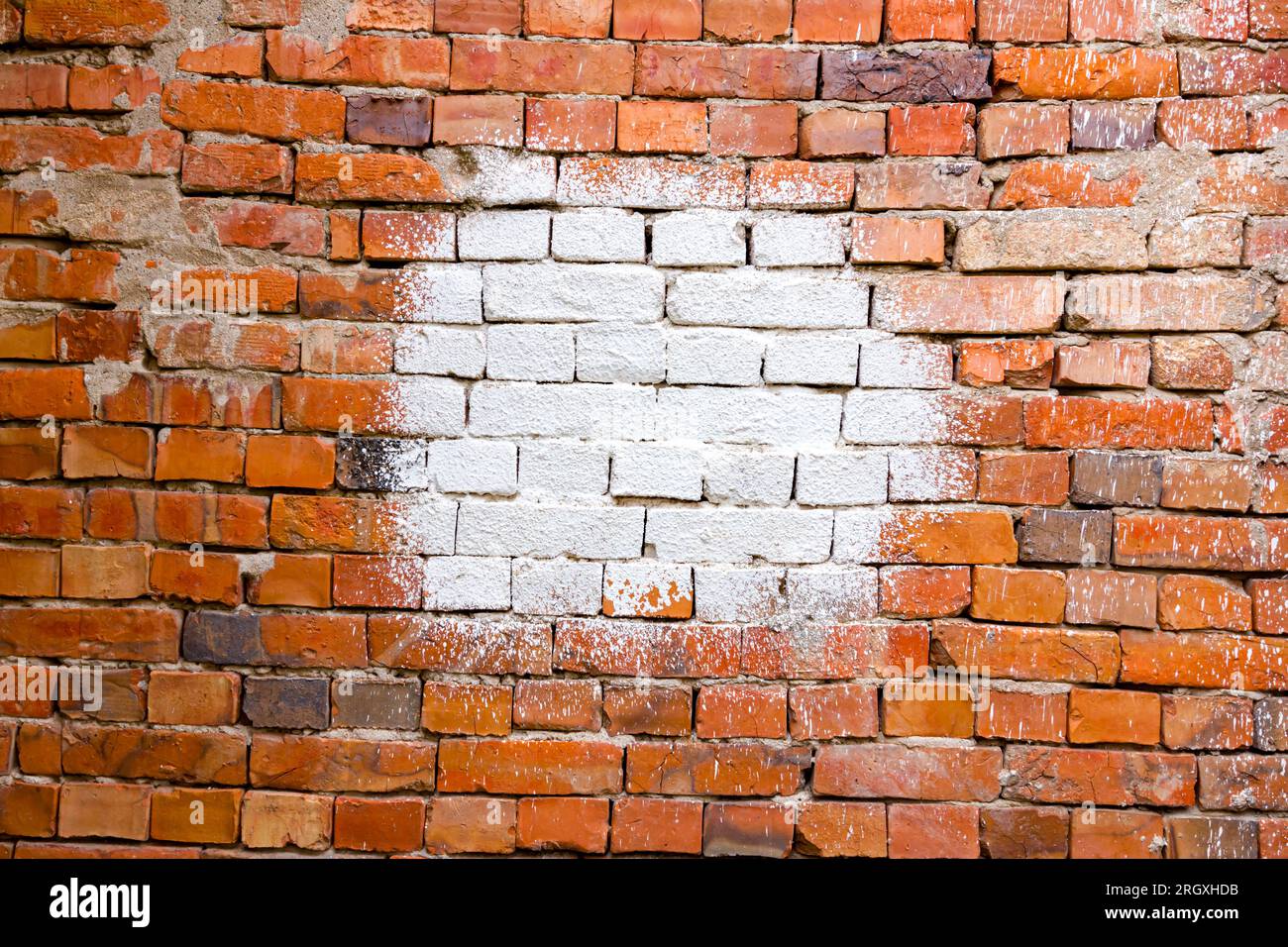 Old dilapidated wall of damaged red bricks stained with a whitewash ...