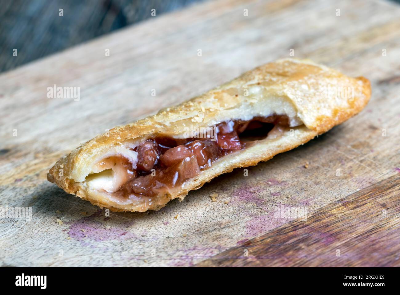wheat pastries with red cherry strawberry filling on a board, dried ...