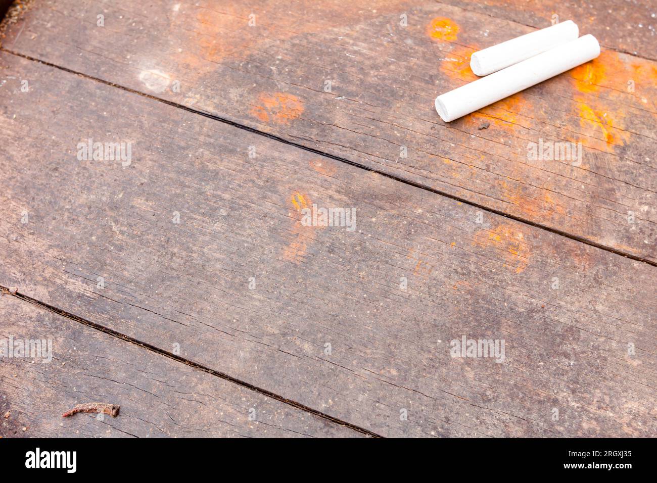 Two white school chalks placed on obsolete brown and rusty wooden ...