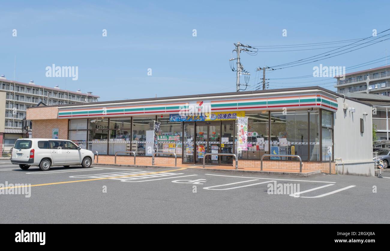A storefront or exterior of a busy 7-Eleven, a famous Japanese ...