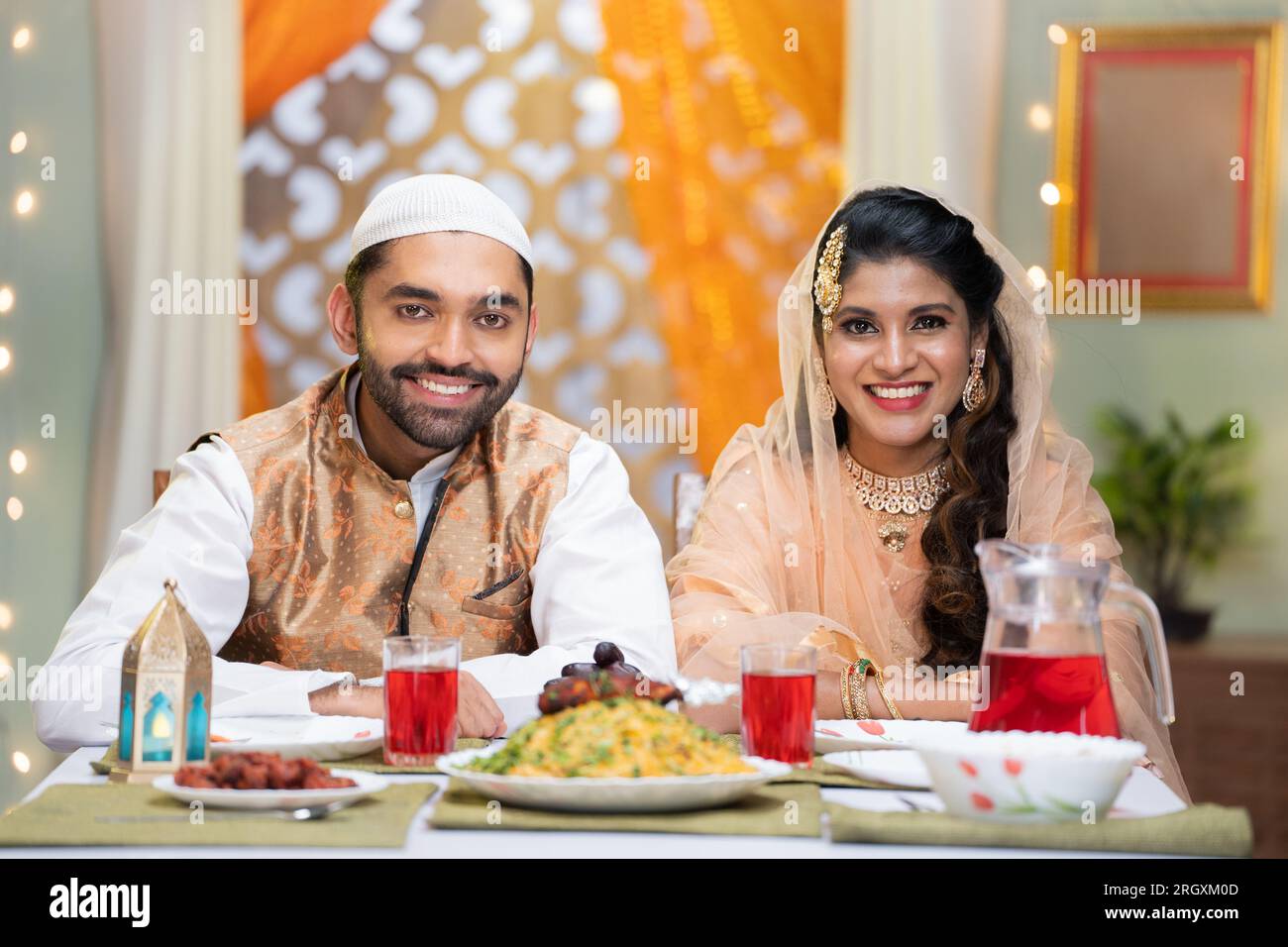 Happy smiling indian muslim couple by looking camera during ramadan ...