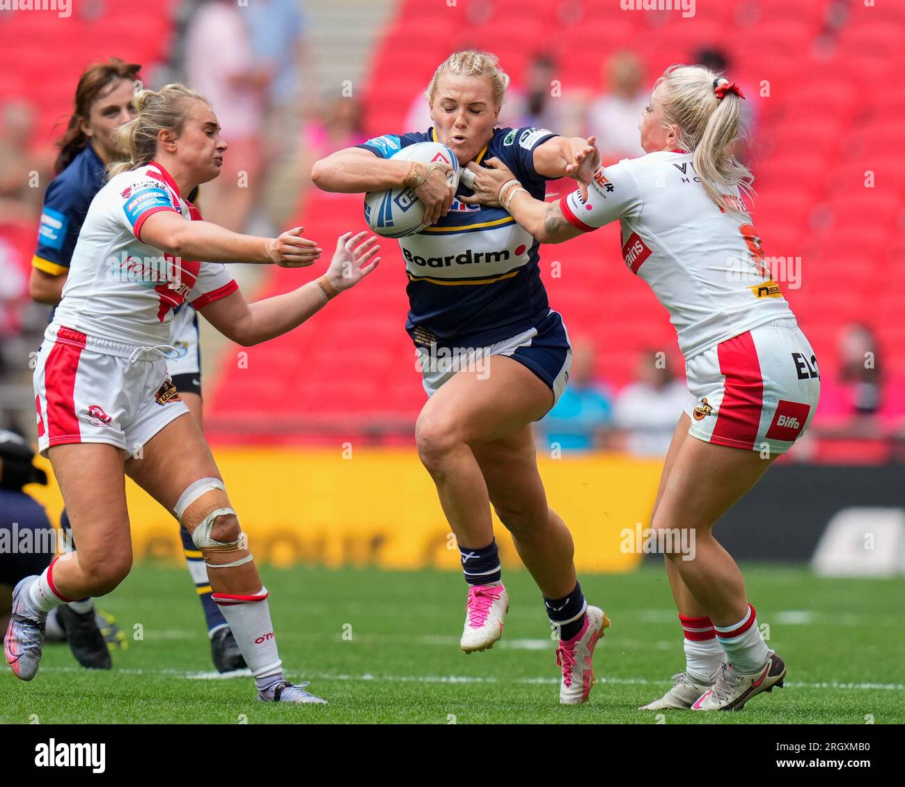 Amy Hardcastle #11 of Leeds Rhinos runs at Shona Hoyle #8 of St. Helens ...