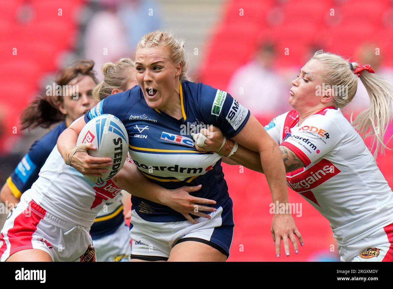 Amy Hardcastle #11 of Leeds Rhinos breaks past Shona Hoyle #8 of St ...