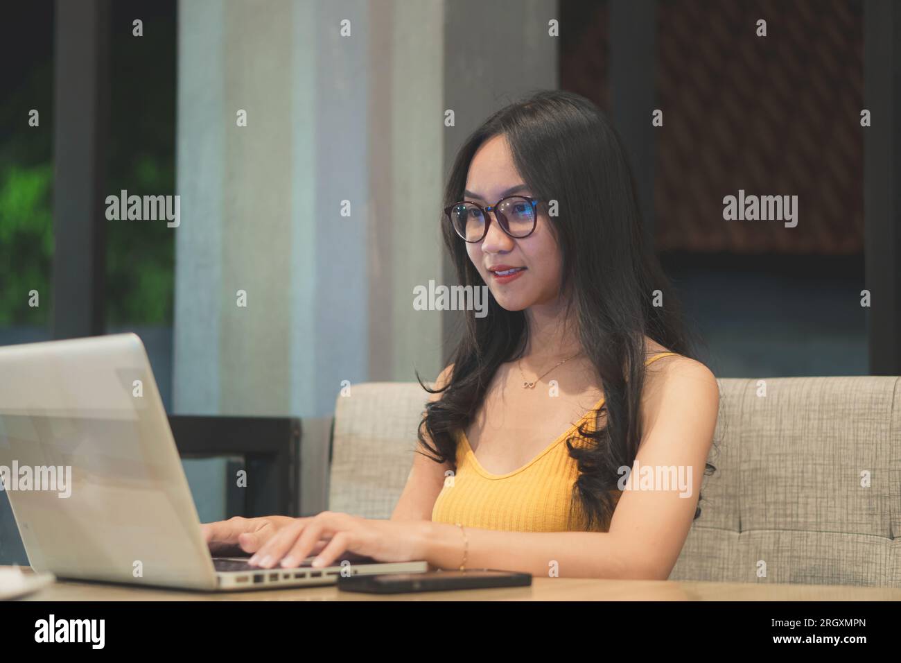 Confident business woman working on laptop at her workplace at office ...