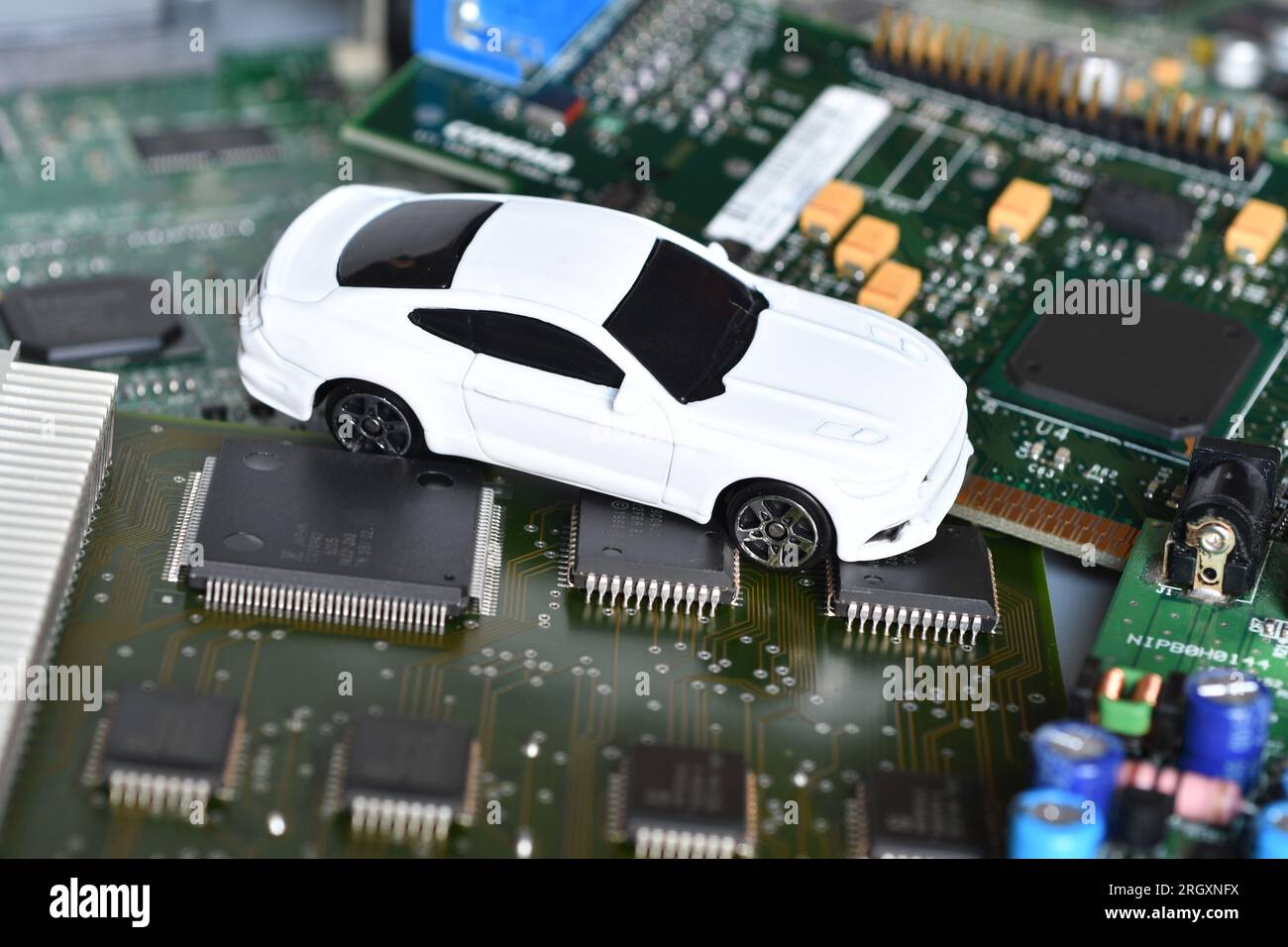 Toy cars on electronic board and microchip. Conceptual image for ...