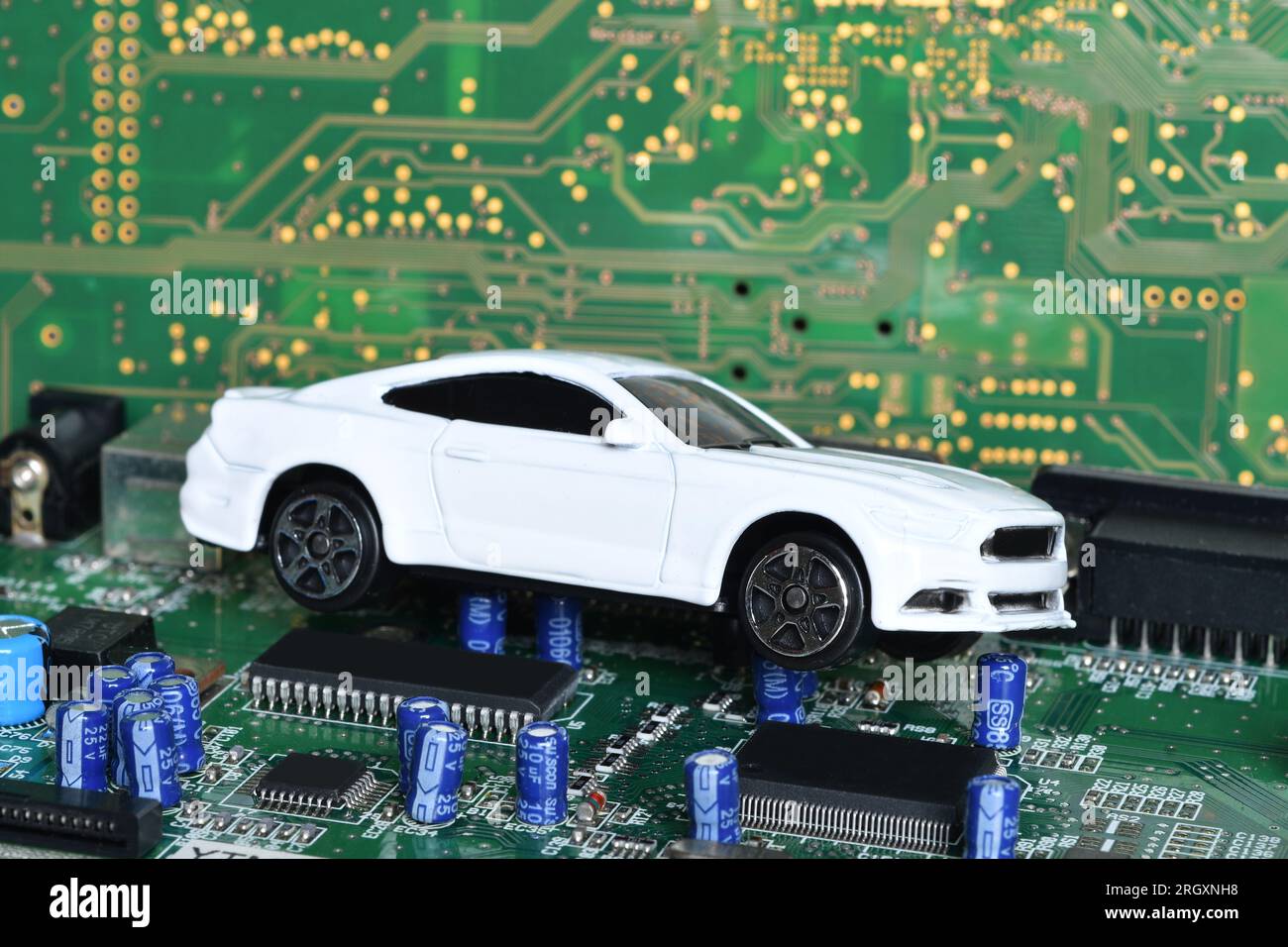 Toy cars on electronic board and microchip. Conceptual image for ...