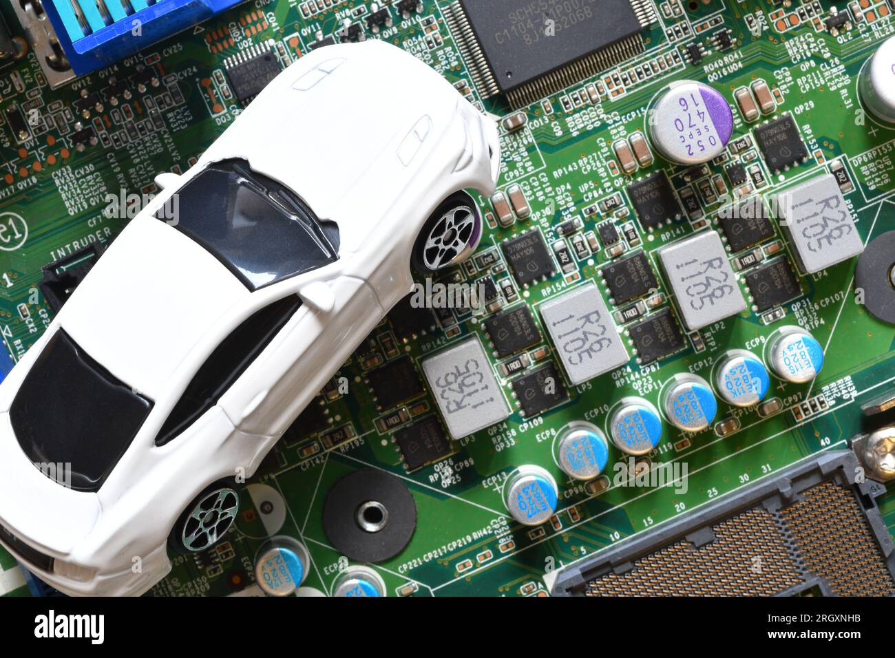 Toy cars on electronic board and microchip. Conceptual image for ...