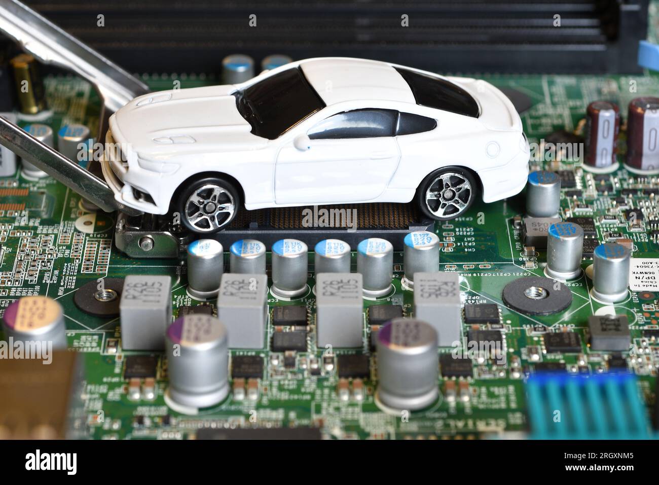 Toy cars on electronic board and microchip. Conceptual image for ...