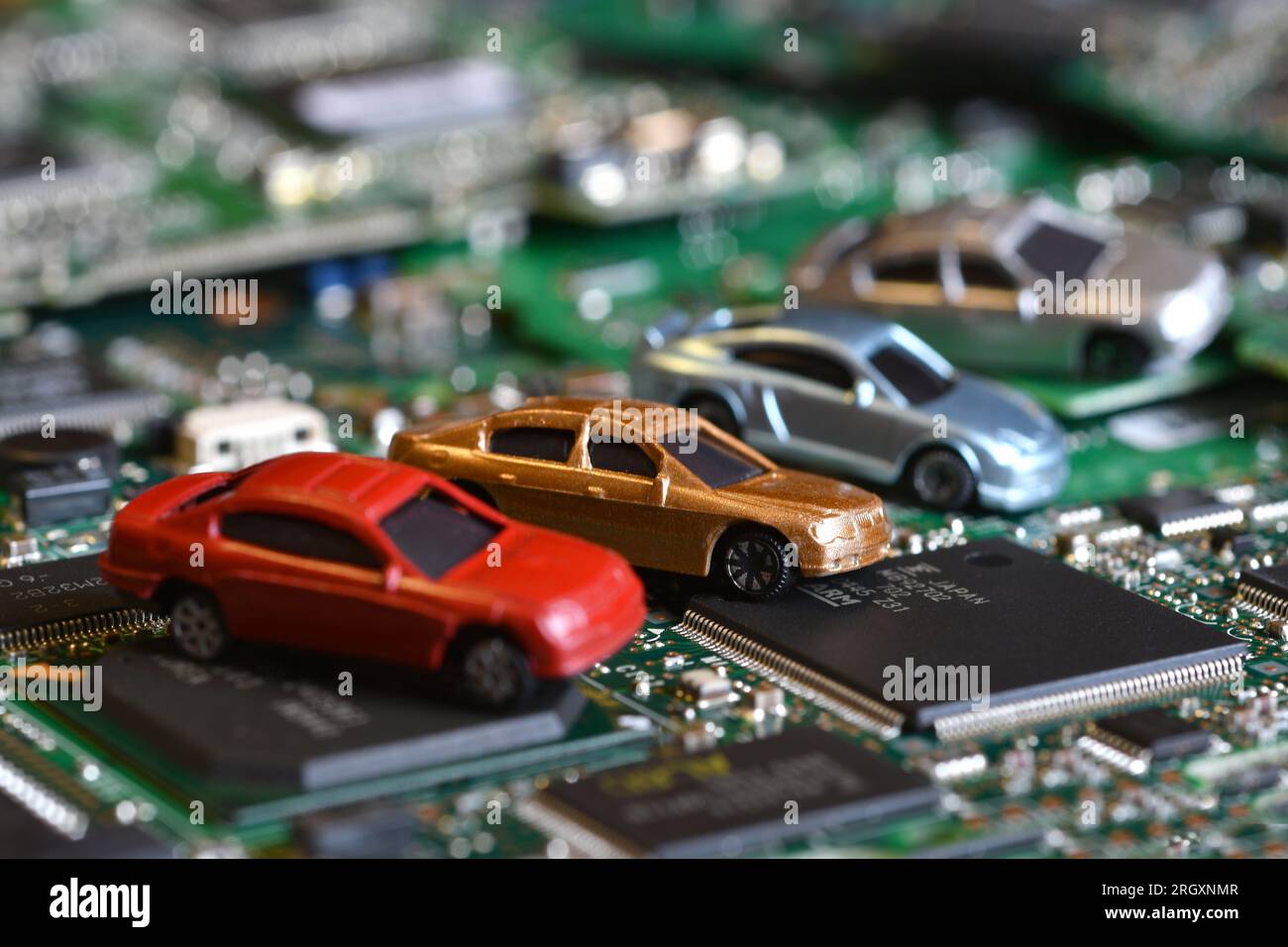 Toy cars on electronic board and microchip. Conceptual image for ...