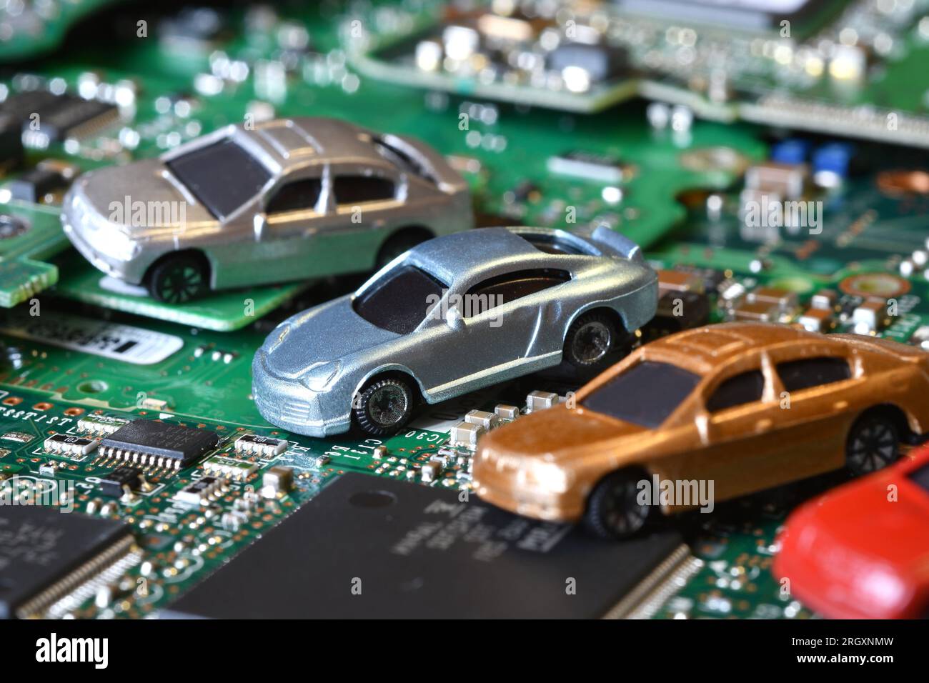 Toy cars on electronic board and microchip. Conceptual image for ...