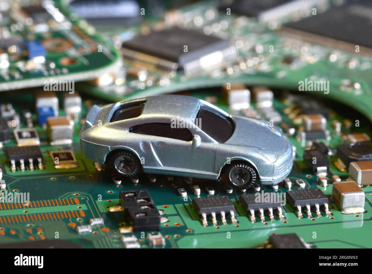 Toy cars on electronic board and microchip. Conceptual image for ...